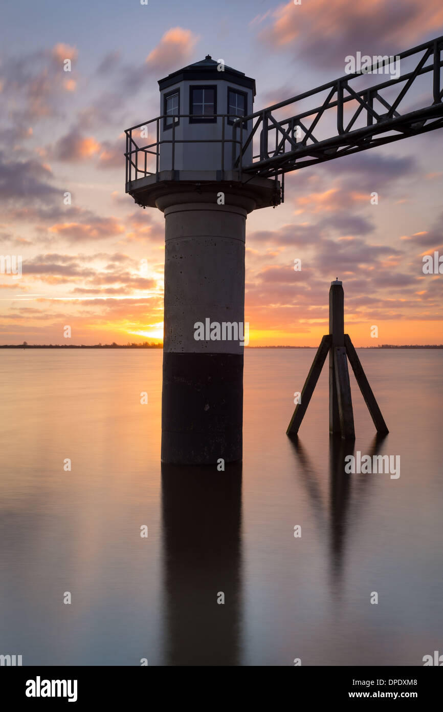 Lighthouse and pier at dawn at lake with cloudscape Stock Photo - Alamy