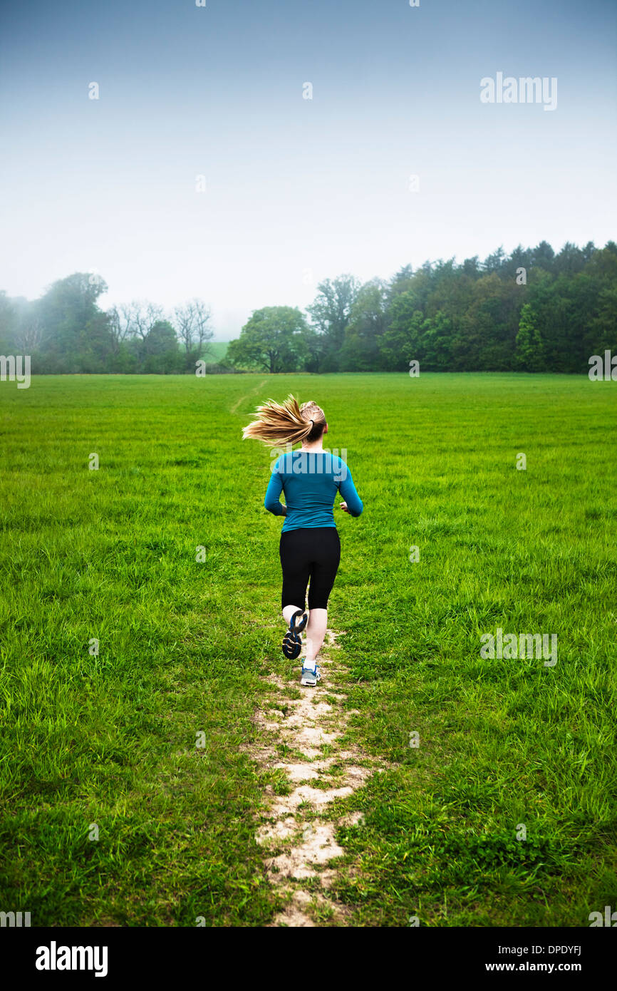 Mature woman running in countryside Stock Photo - Alamy