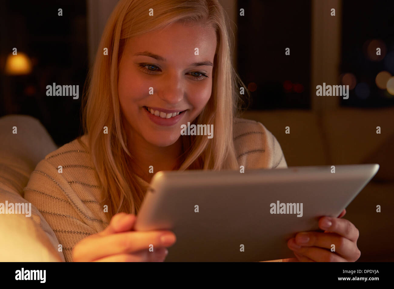 Young woman using tablet night hi-res stock photography and images - Alamy
