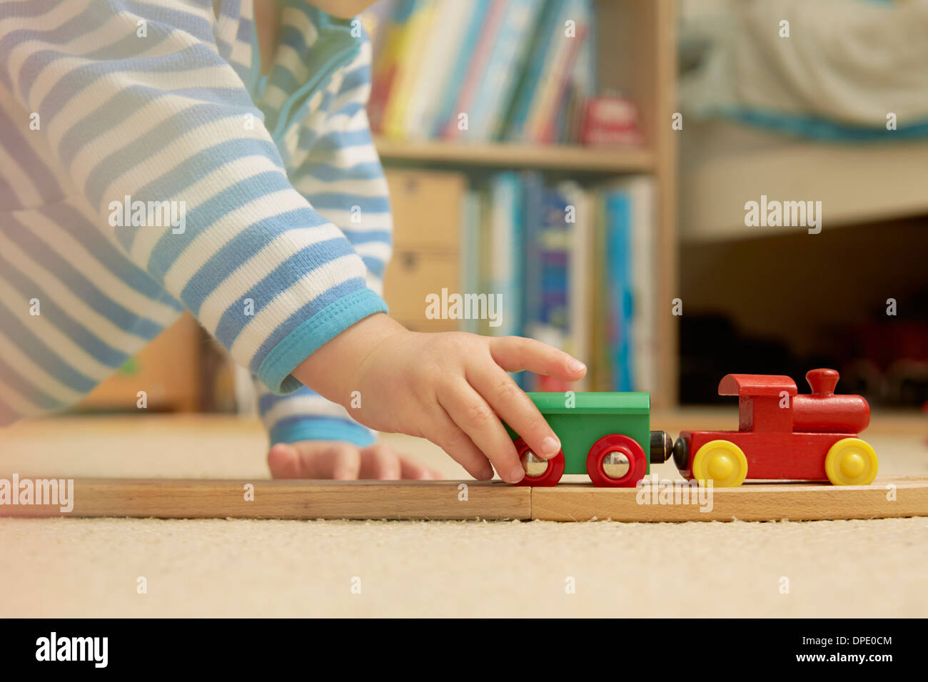 Baby boy playing with train set Stock Photo - Alamy