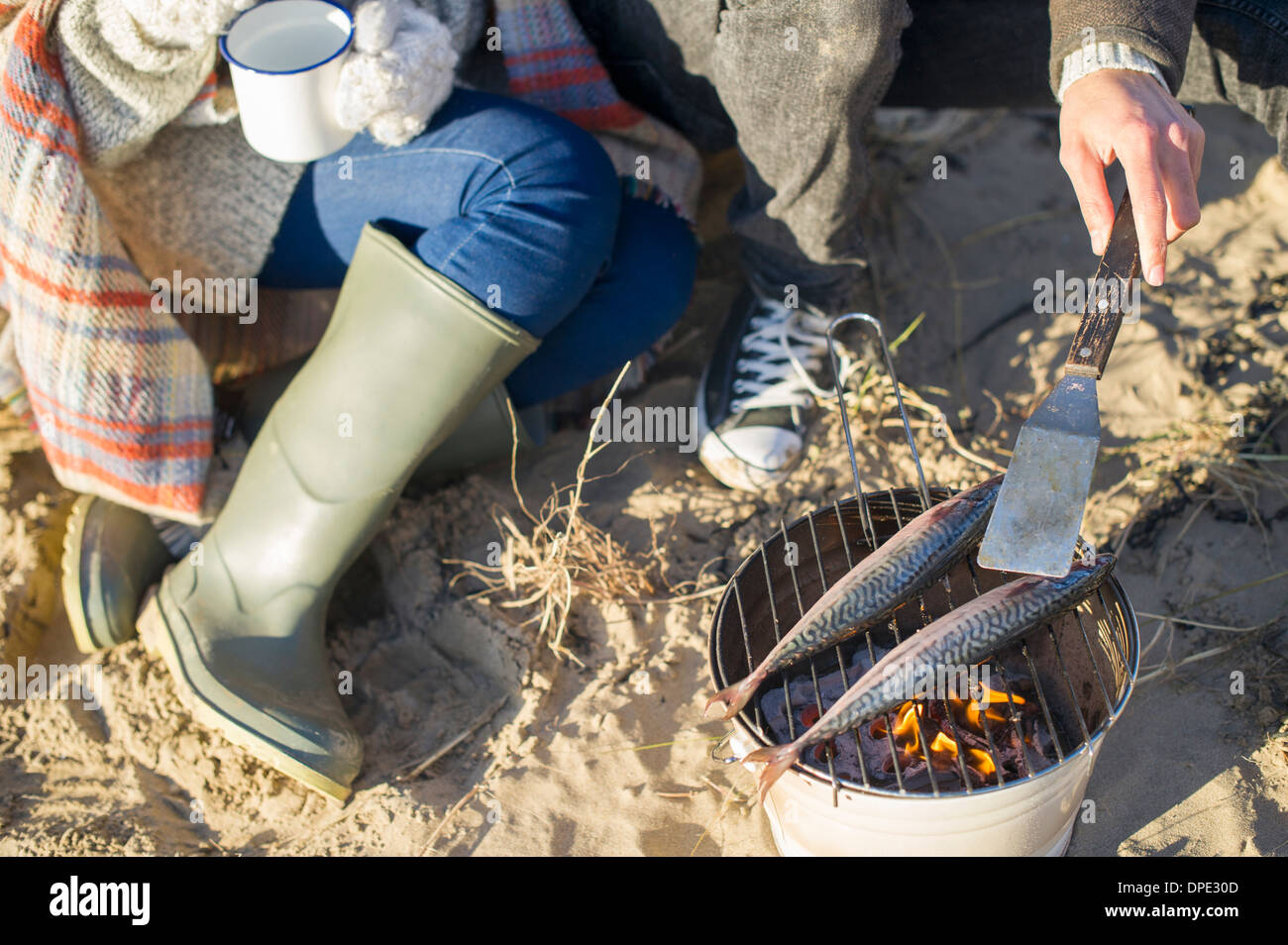 Cooking fish on the beach Stock Photo - Alamy