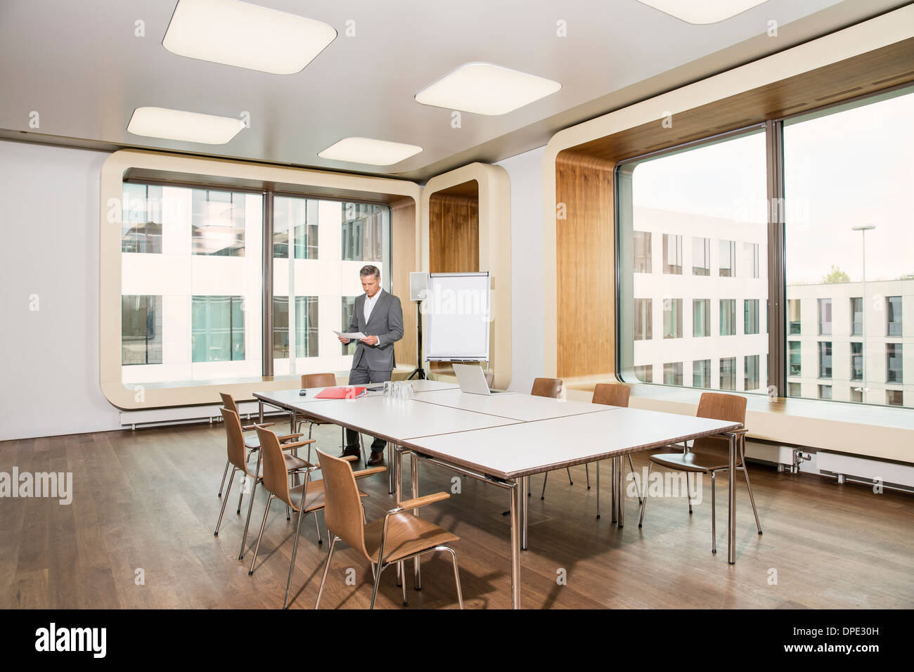 Businessman standing conference room hi-res stock photography and ...