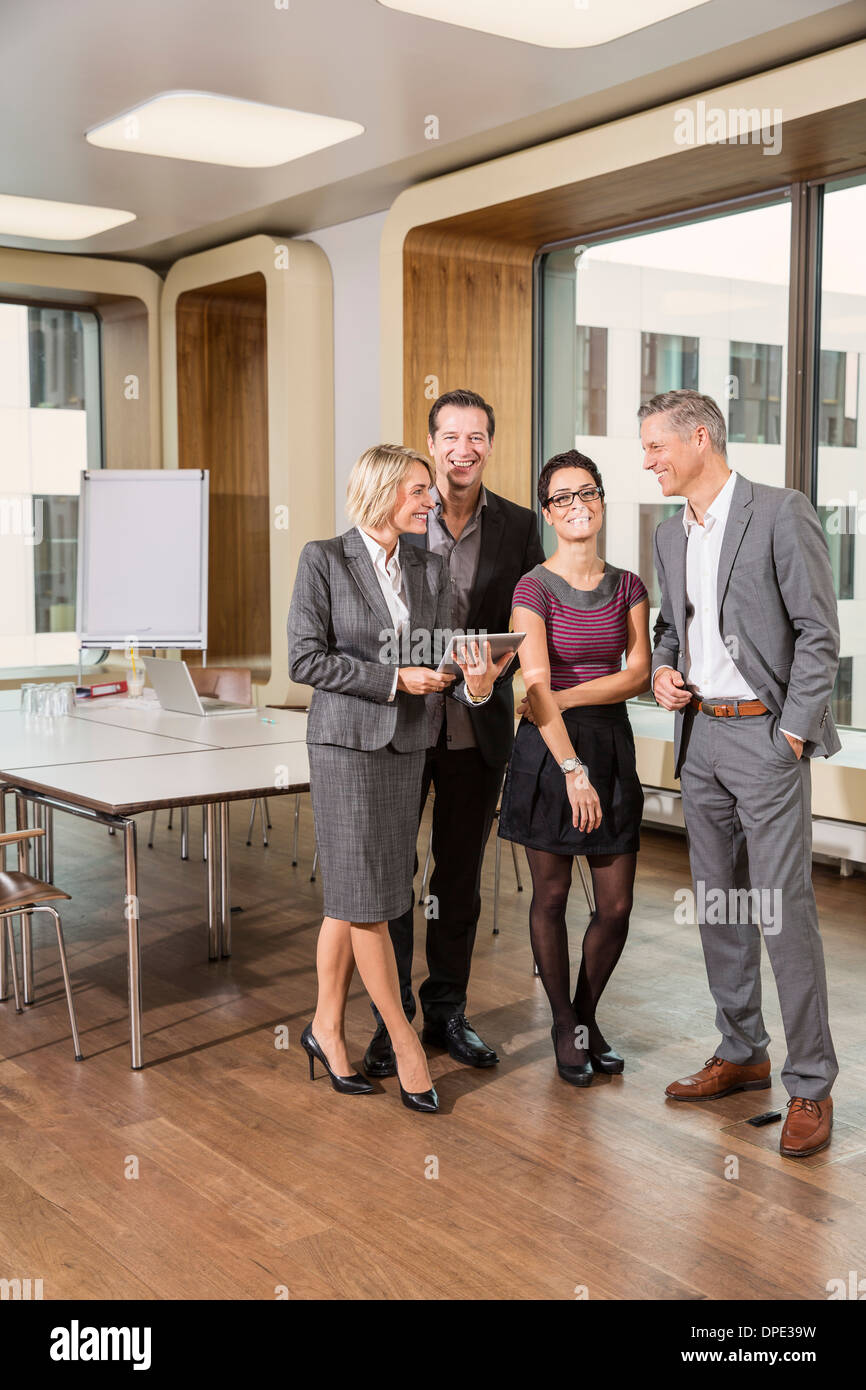 Businesspeople standing in conference room Stock Photo - Alamy