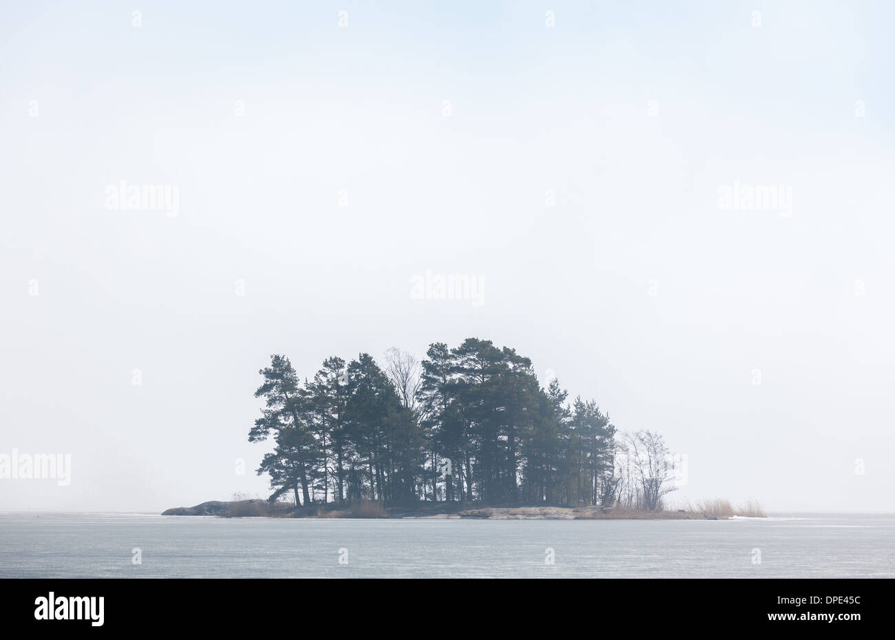 Misty island in the sea Stock Photo - Alamy