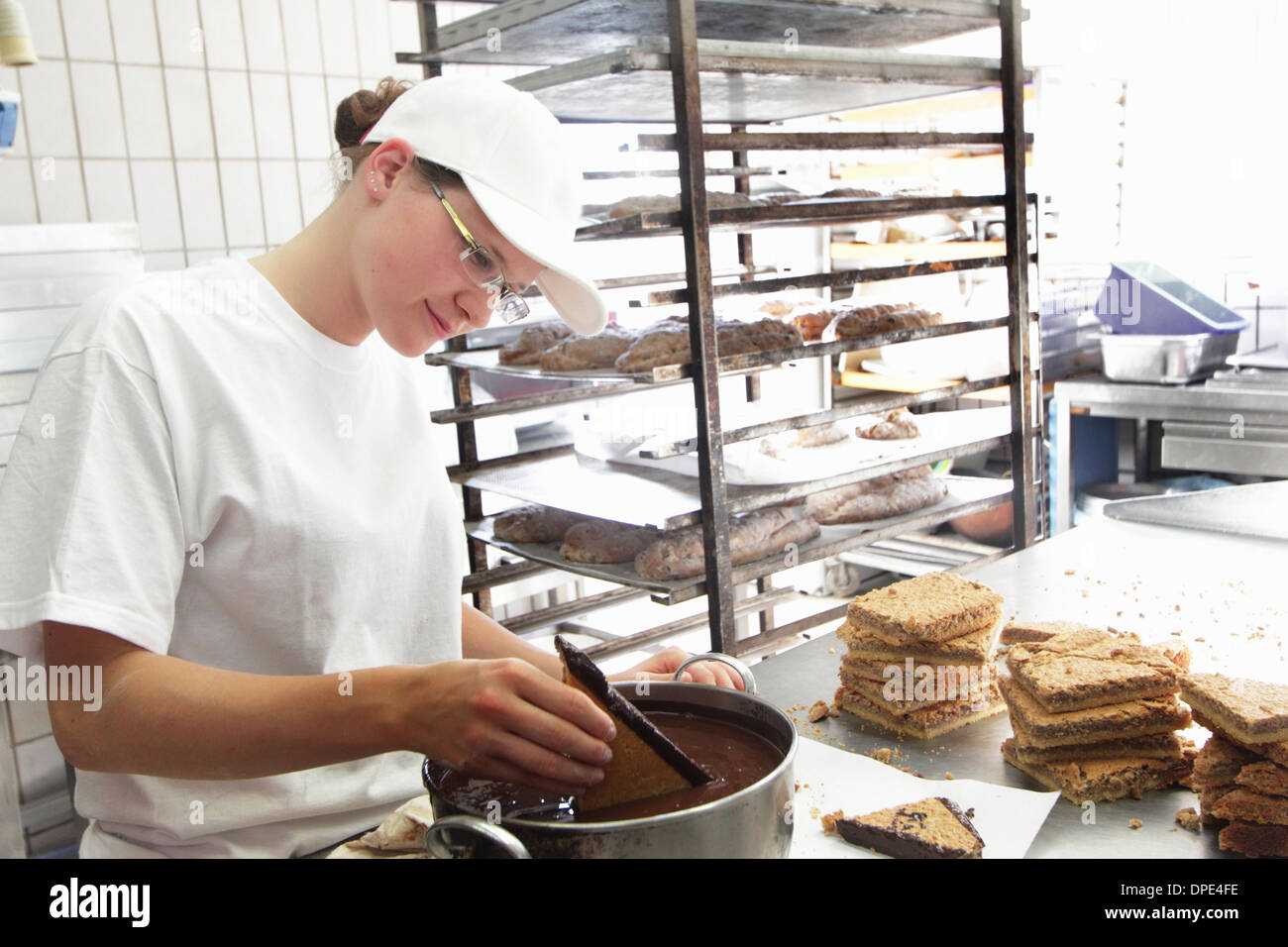 Baker stirring mixture Stock Photo - Alamy
