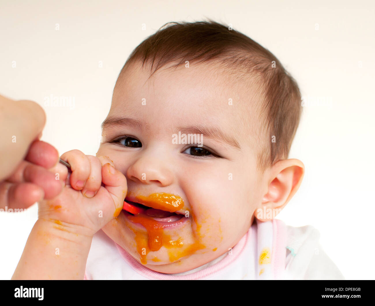 Baby eating baby food Stock Photo - Alamy
