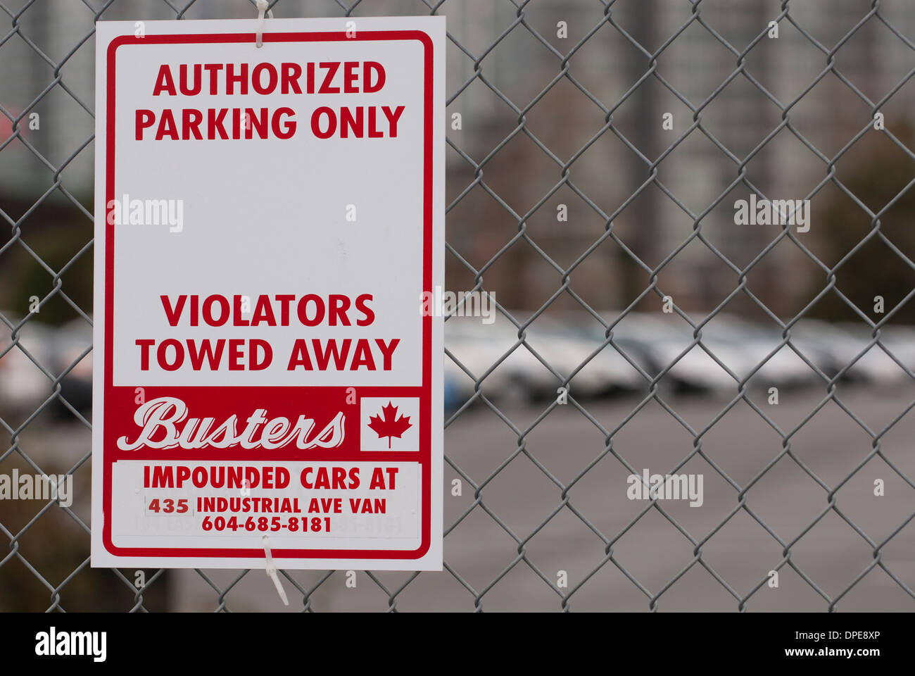 Authorized Parking only warning sign attached to chain link fencing ...