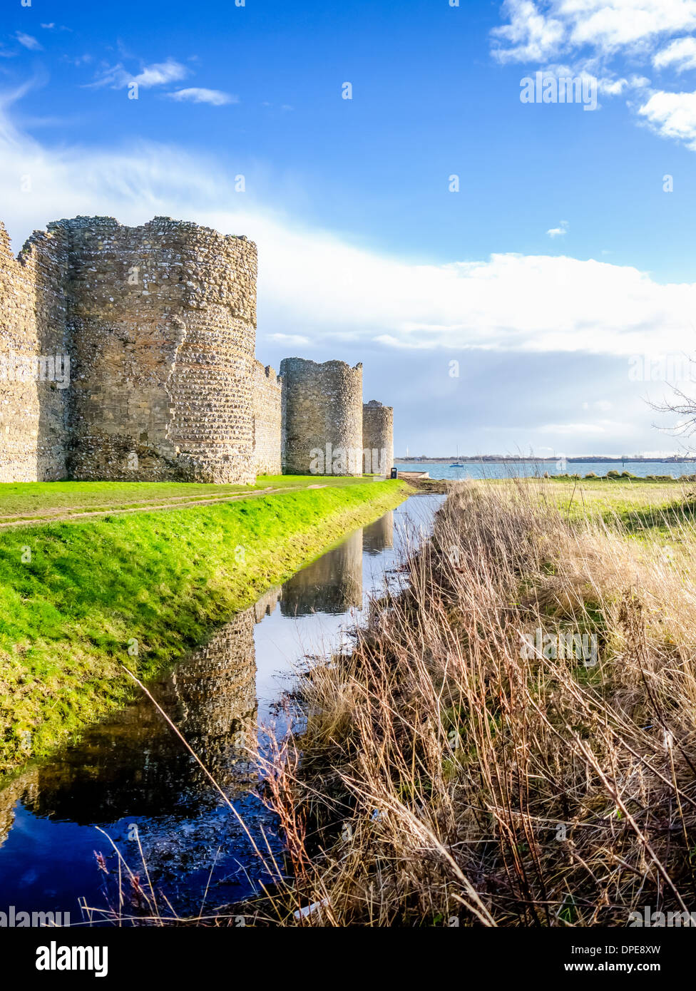 The external Roman walls of Portchester Castle are reflected in the ...