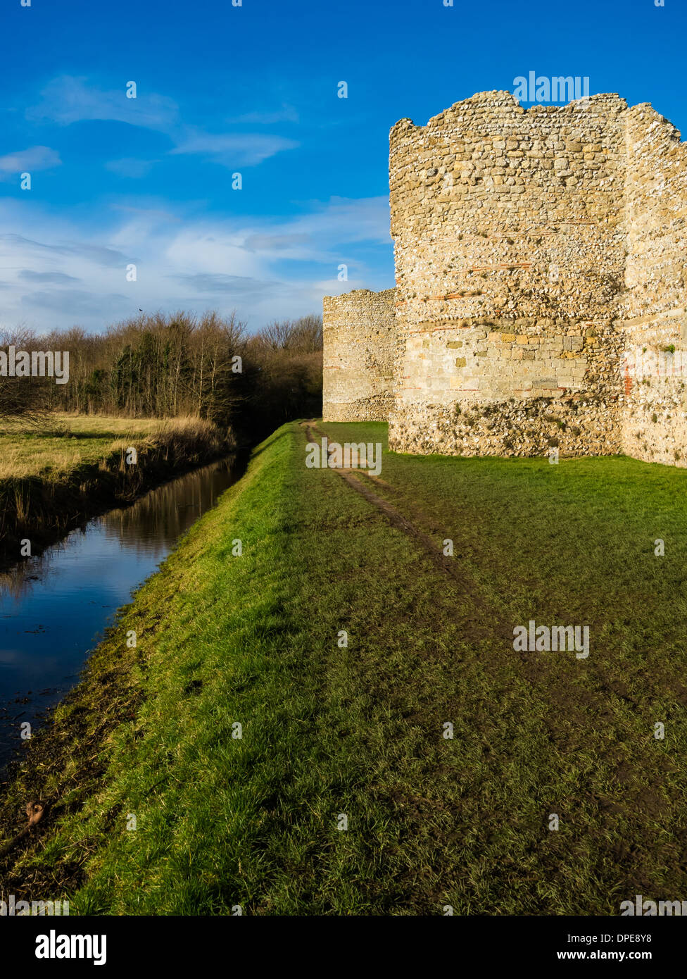 The external Roman walls of Portchester Castle and moat that has been ...
