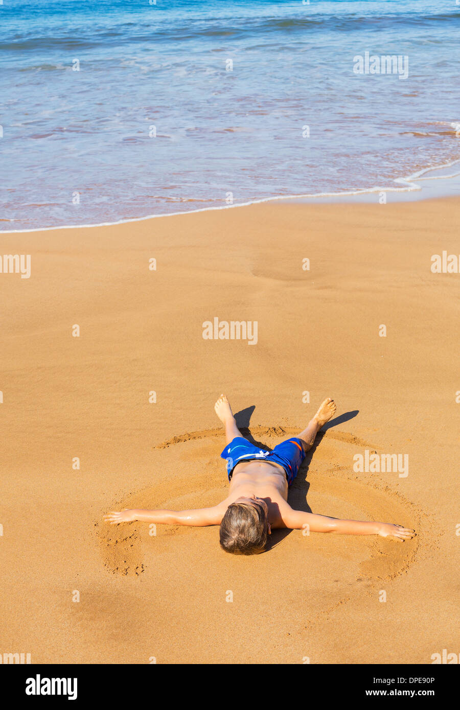 Child laying in sand hi-res stock photography and images - Alamy