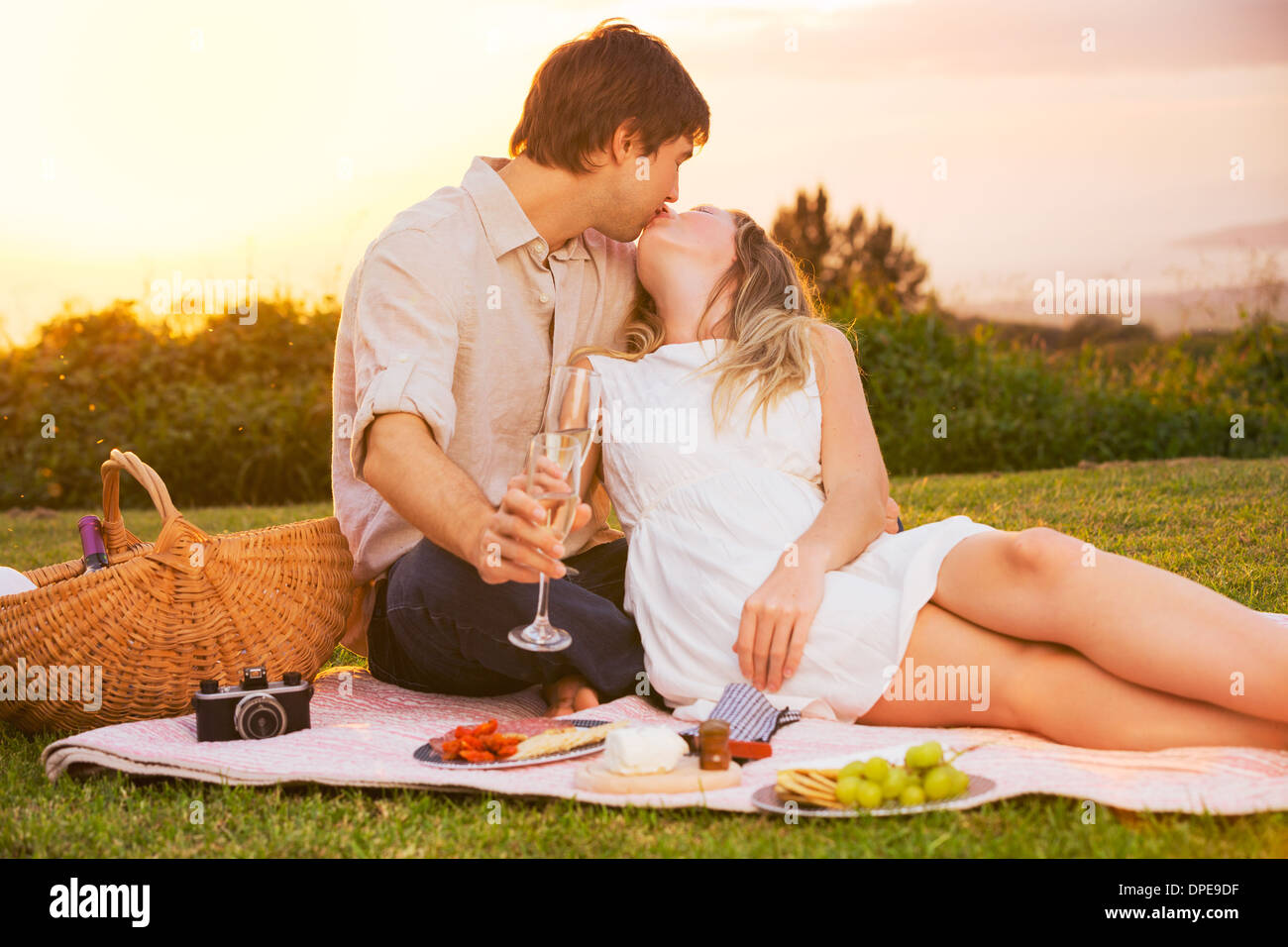Attractive Couple Enjoying Romantic Sunset Picnic in the Countryside Stock Photo - Alamy