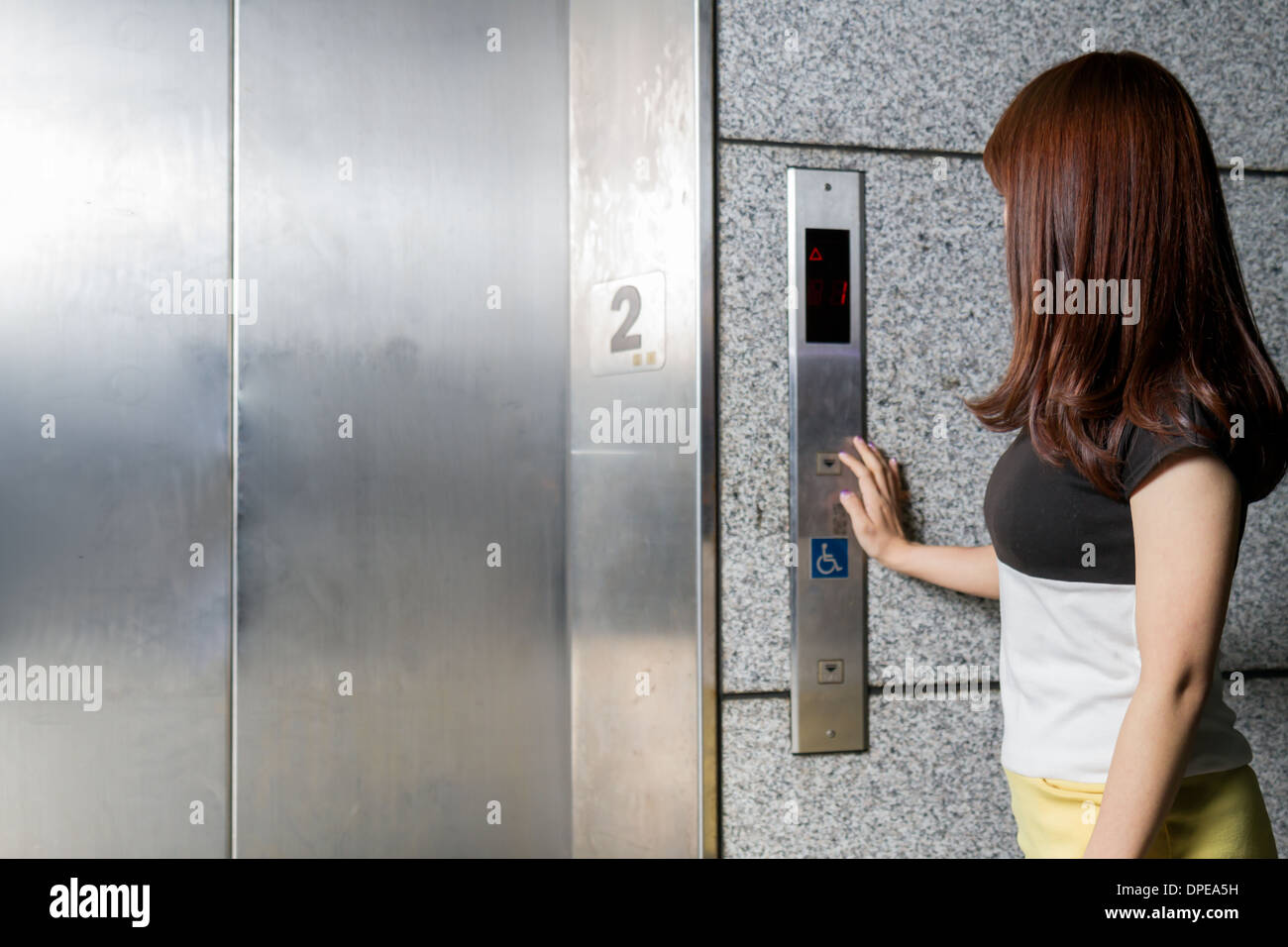 Attractive Japanese female at an elevator Stock Photo - Alamy