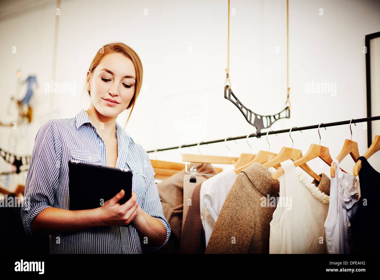 Shop keeper doing stock check using digital tablet Stock Photo - Alamy