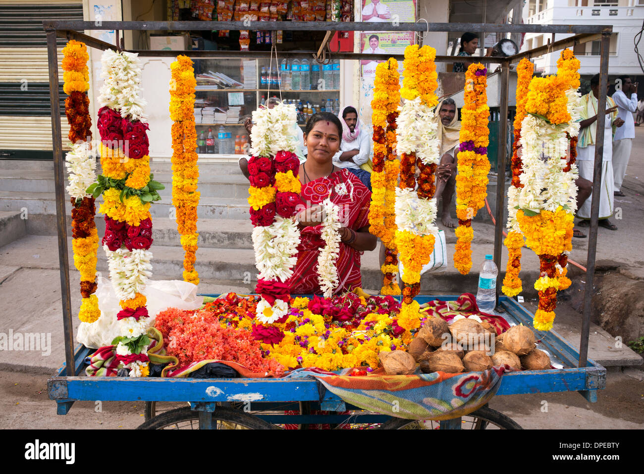 Indian woman selling flowers and garlands for hindu temple worship ...