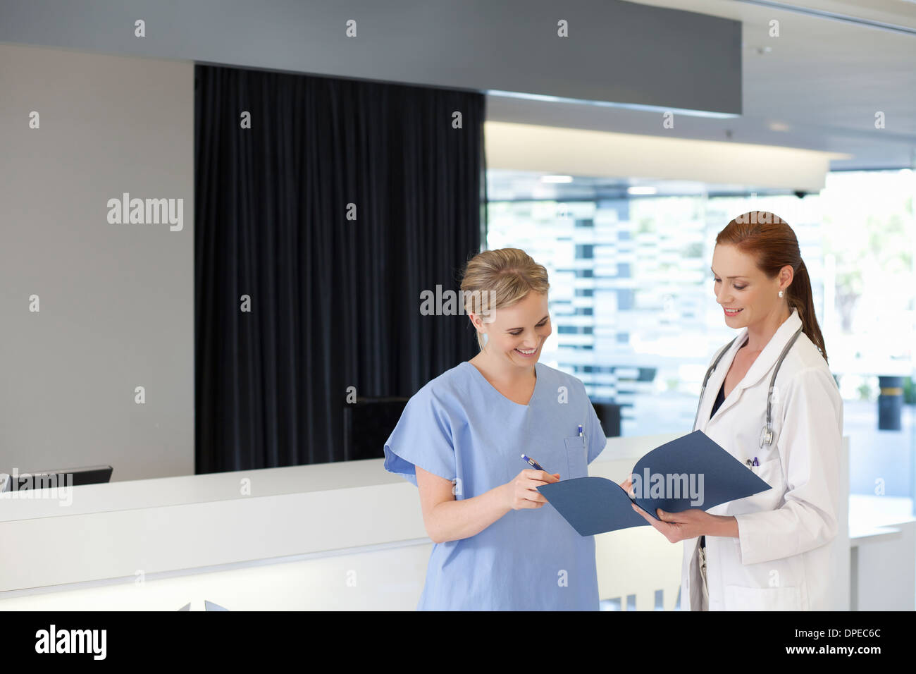 Doctor and nurse looking at paperwork Stock Photo - Alamy