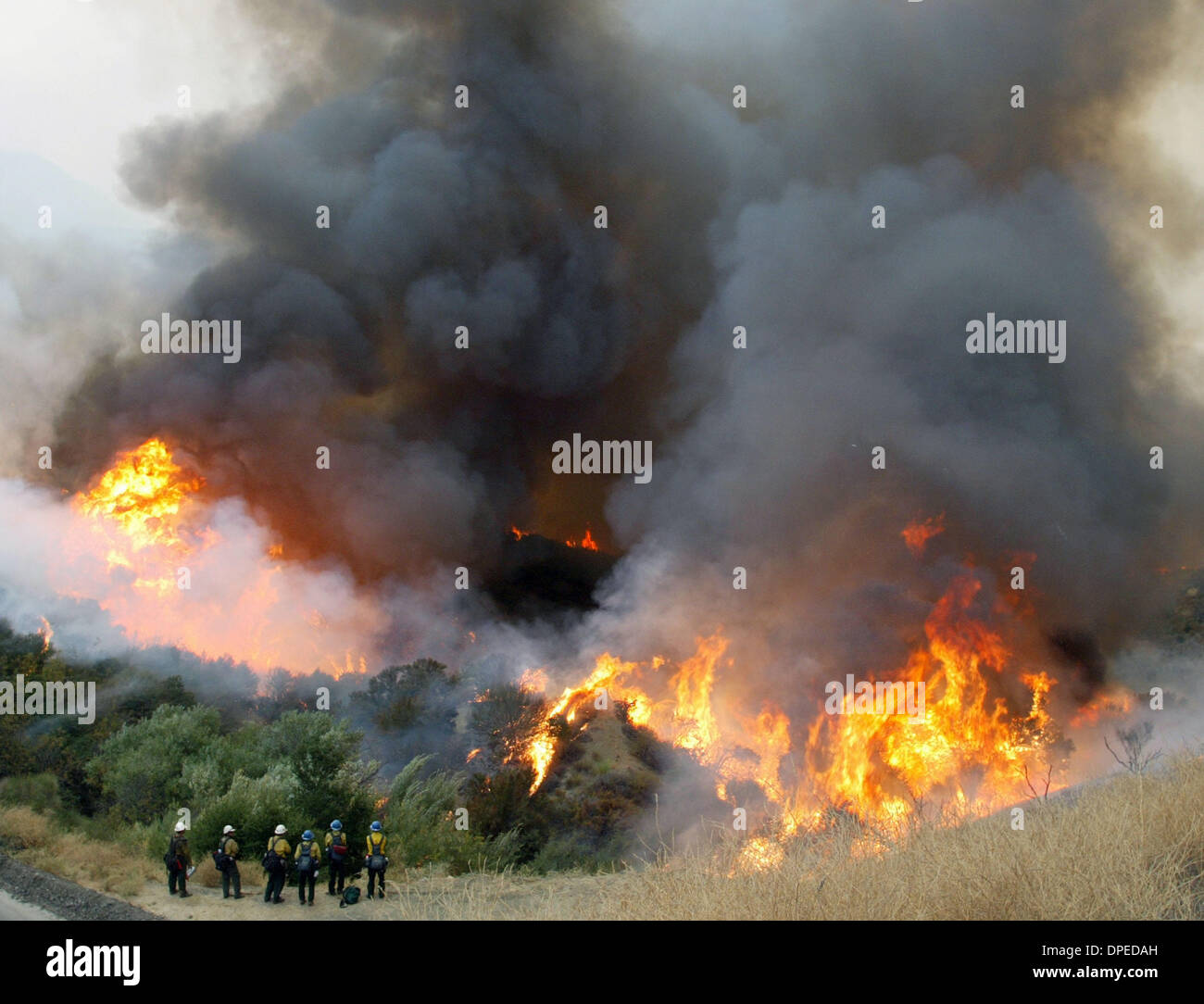 Sep 12, 2006; Castaic, CA, USA; Firefighters monitor the flames in the ...