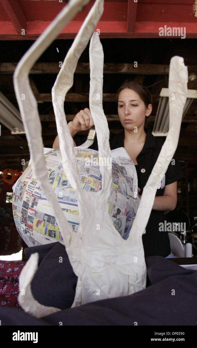 (Published 6/8/2005, NC-6) Tiffany Delgado paints the head of a huge ...