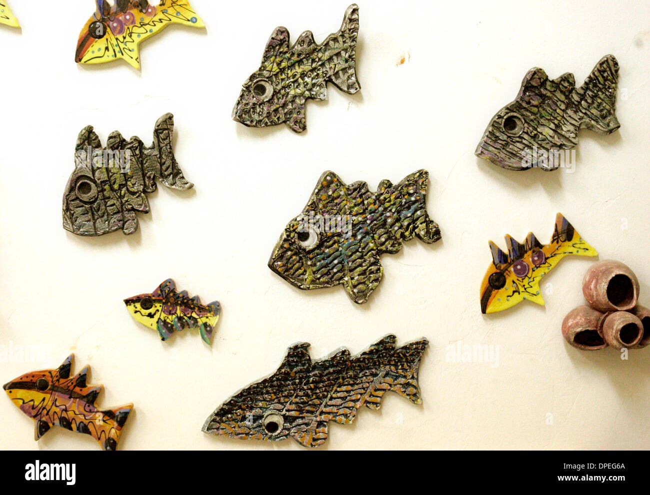 (Published 2/11/2006, NC-4) Fish sculptures hang on the wall at the ...
