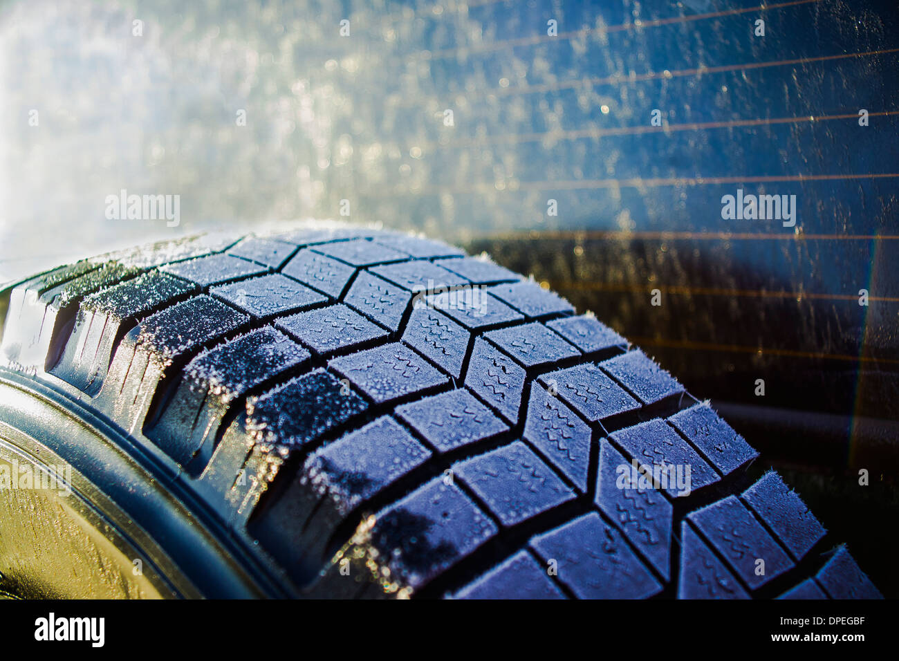 Crystals of the ice on spare tire of off road vehicle, close up outdoor ...