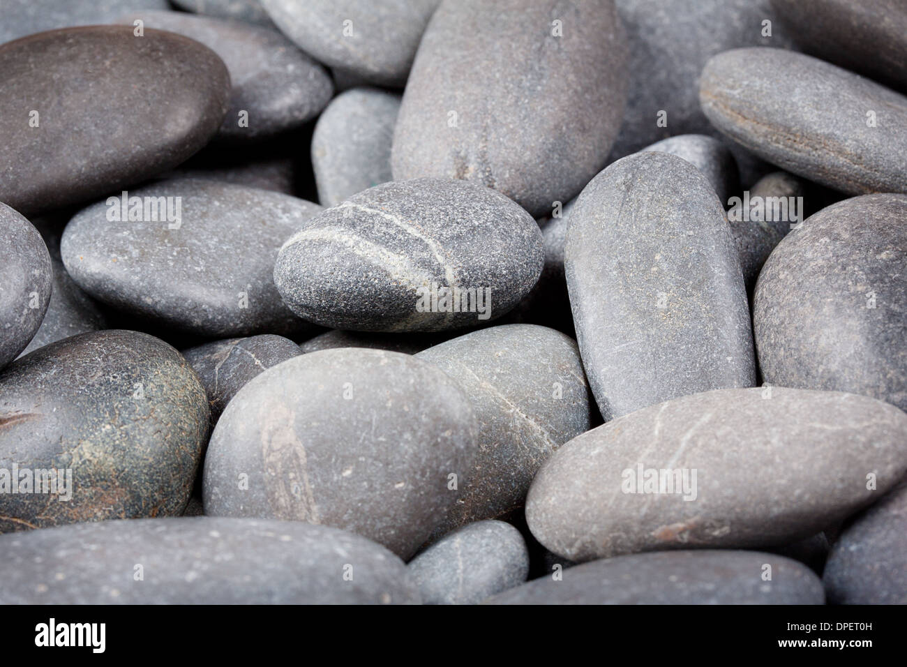 Background of dark round small sea stones Stock Photo - Alamy