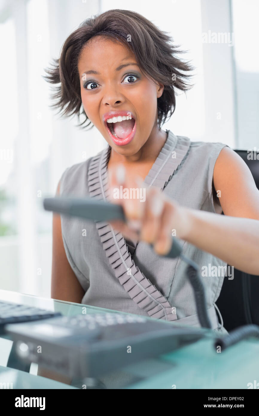 Screaming businesswoman hanging up the phone Stock Photo - Alamy