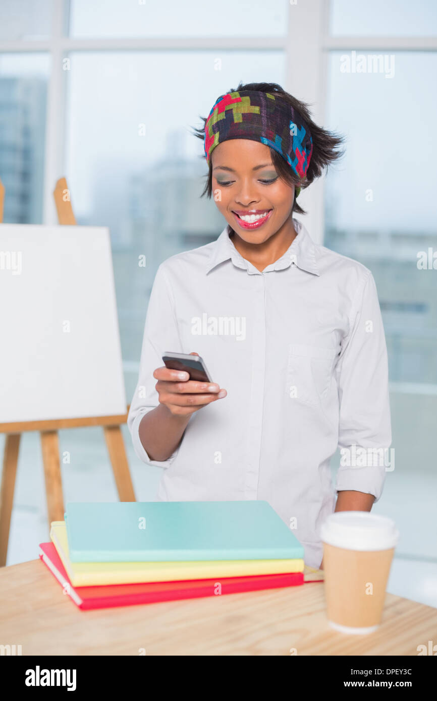 Smiling artist using her phone Stock Photo - Alamy