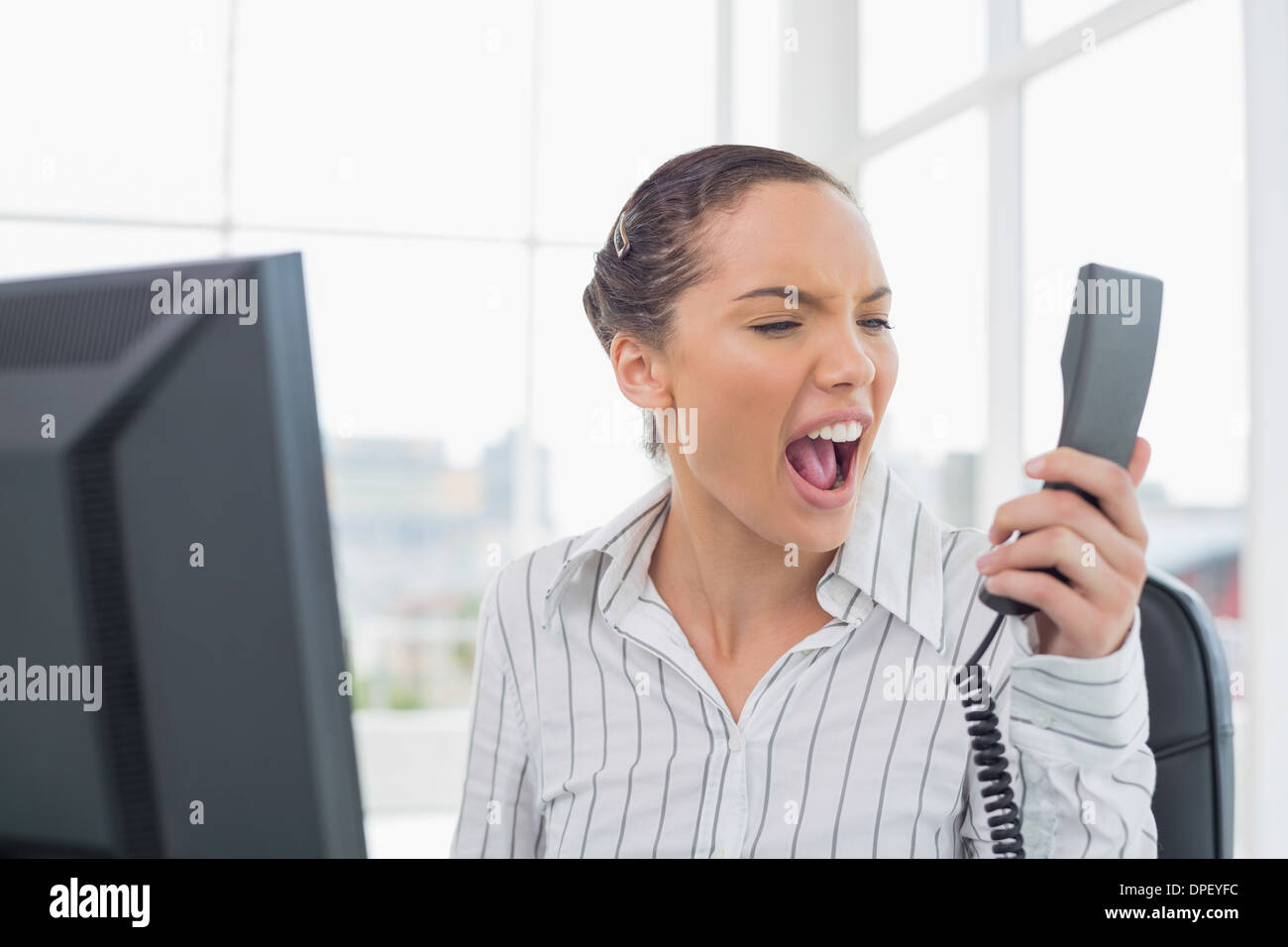Angry businesswoman screaming at phone Stock Photo - Alamy