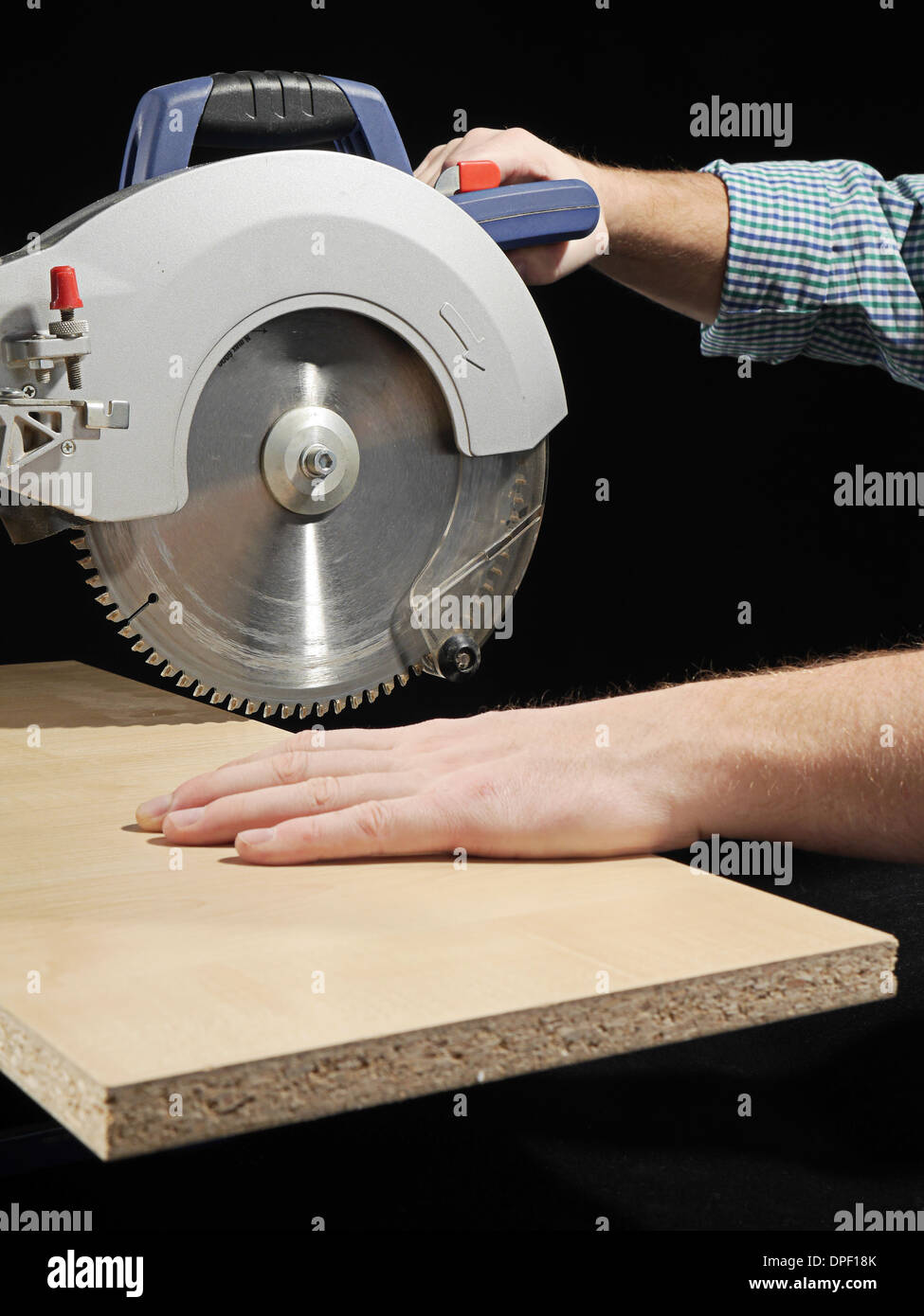 Carpenter cutting flaxboard using sliding compound mitre saw Stock ...