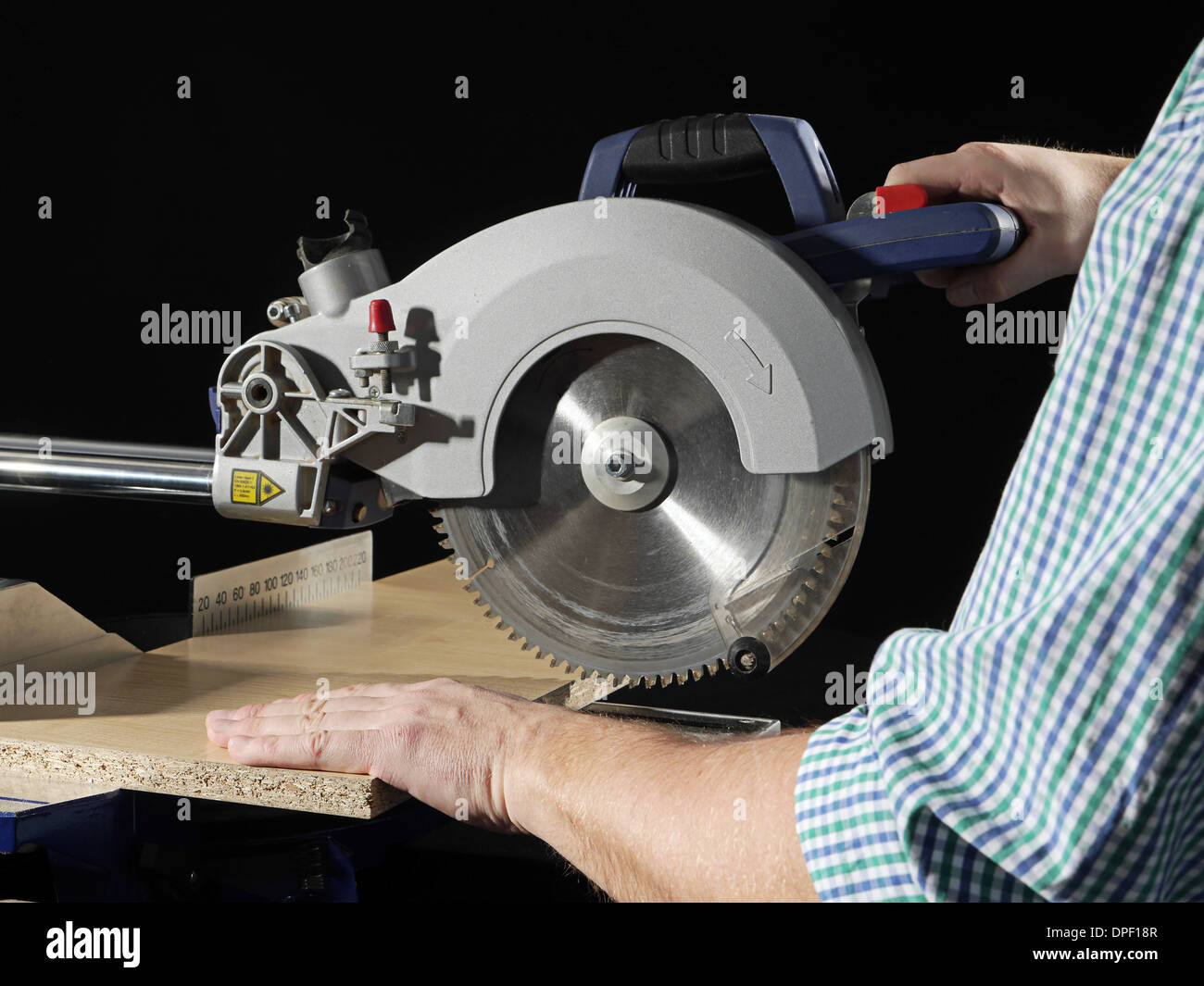 Carpenter cutting flaxboard using sliding compound mitre saw Stock ...