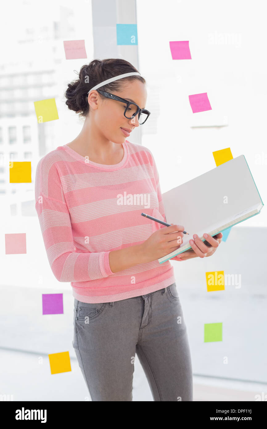 Concentrated attractive artist drawing on her sketchpad Stock Photo - Alamy
