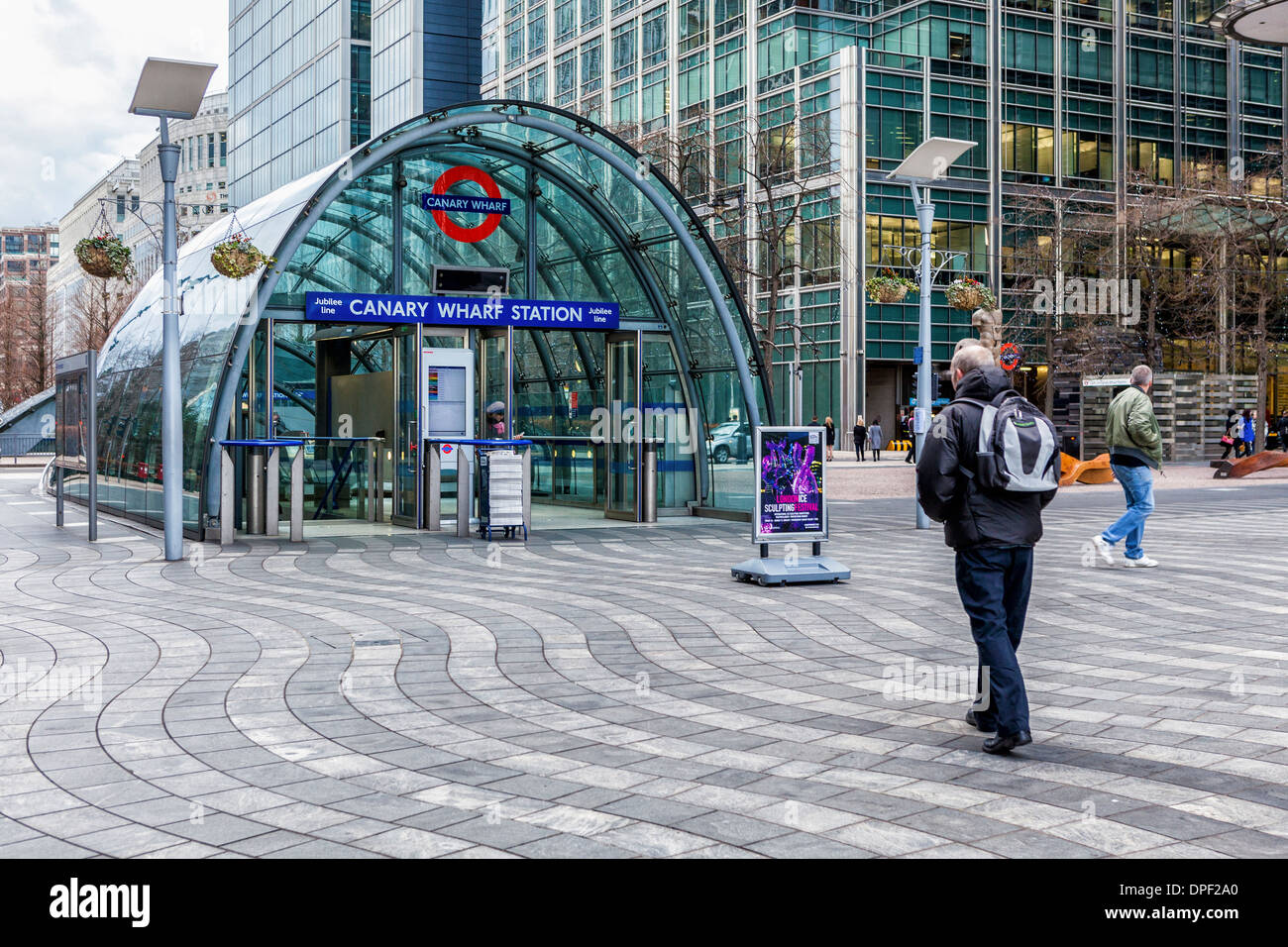 Senior man with backpack walking towards entrance of London Underground ...