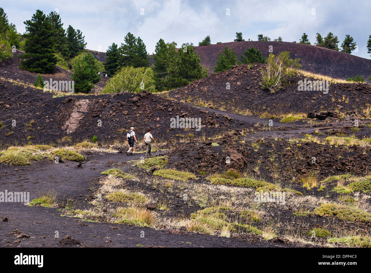 Tourists visiting an old lava flow from an eruption on Mount Etna ...