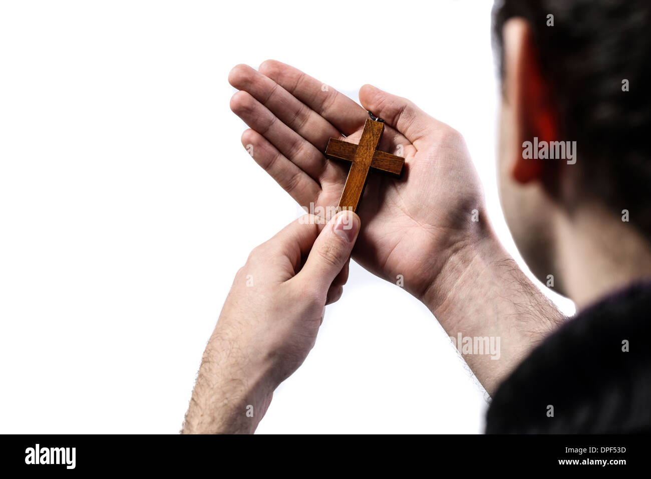 Male hands holding wooden cross on white background Stock Photo - Alamy