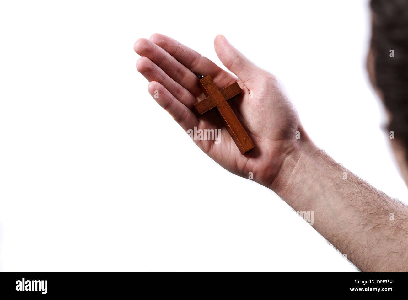 Male hand holding wooden cross on white background Stock Photo - Alamy