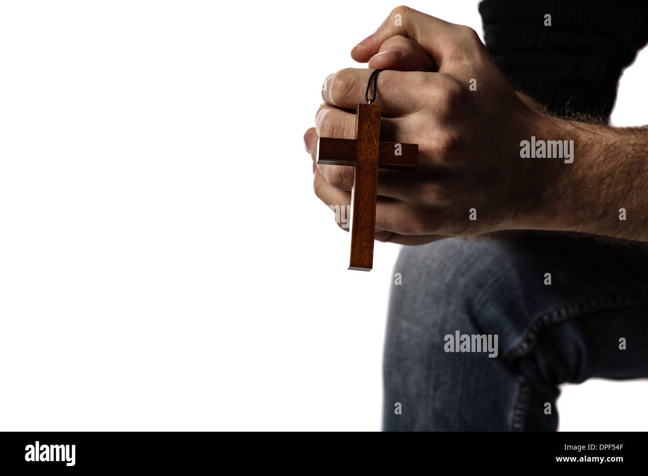 Male hands holding wooden cross on white background Stock Photo - Alamy