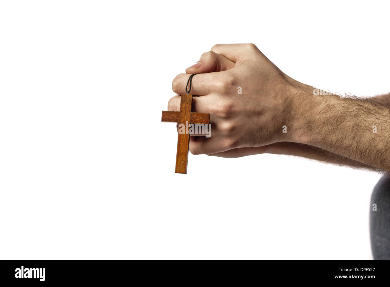 Male hands holding wooden cross on white background Stock Photo - Alamy