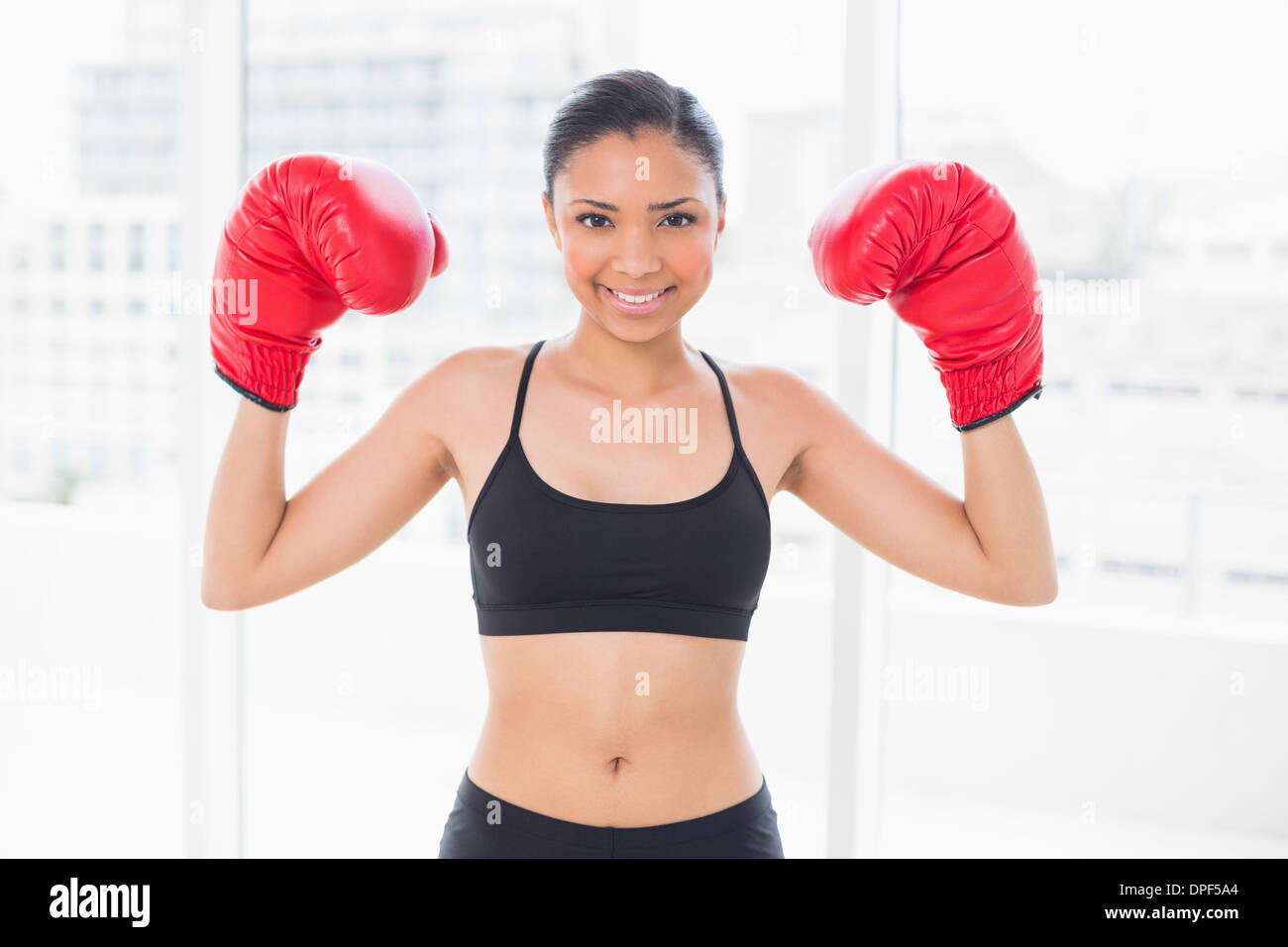 Lovely dark haired model in sportswear wearing red boxing gloves Stock ...