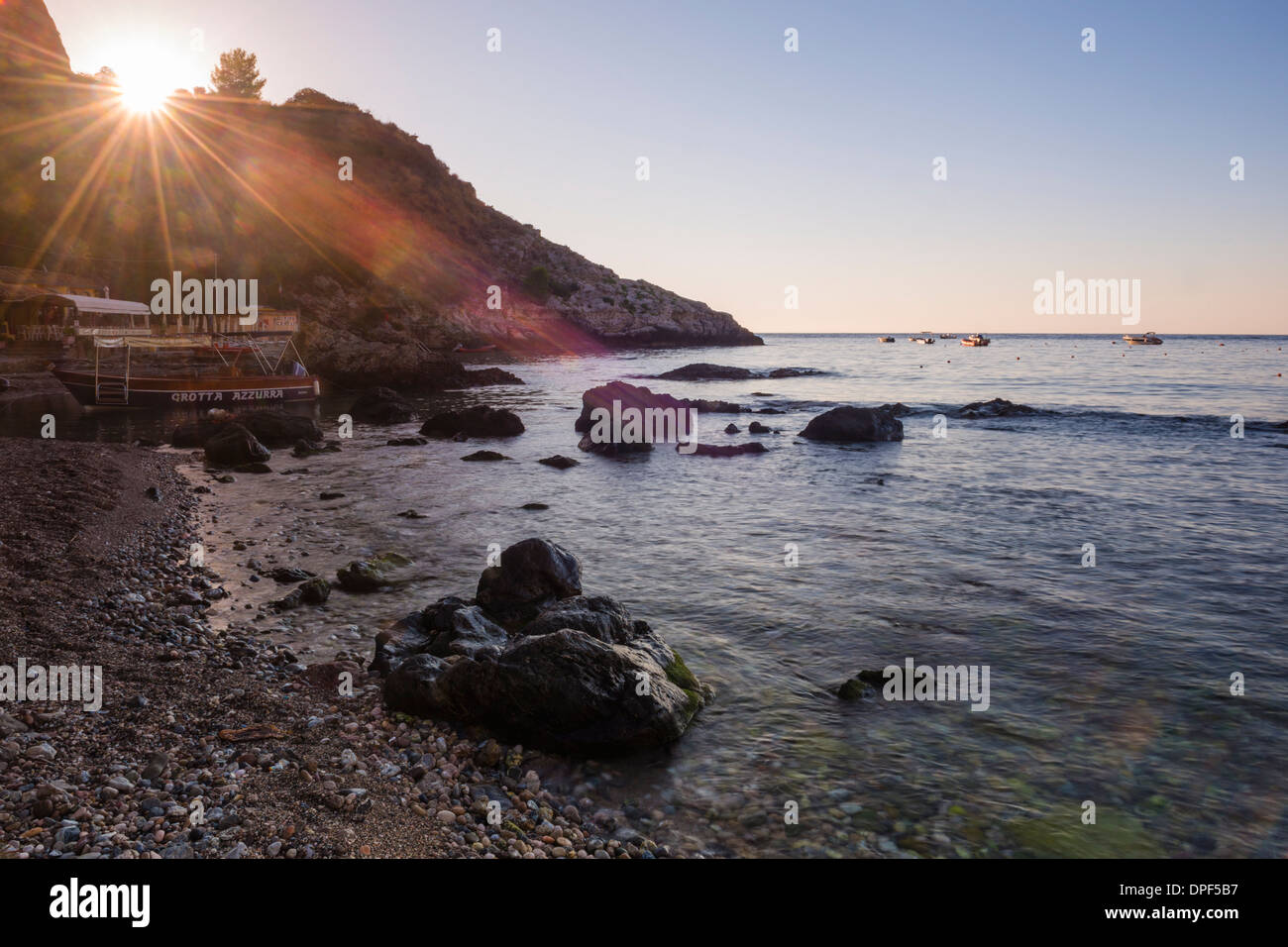 Sunstar at Isola Bella Beach at sunrise, Taormina, Sicily, Italy ...