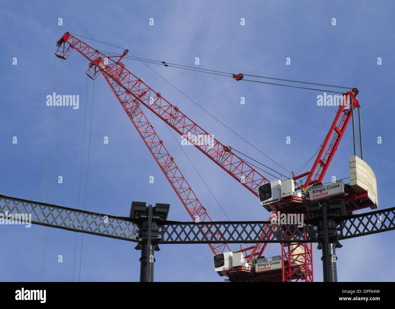 Cranes around the old gas holder frame at King's Cross, London, England ...