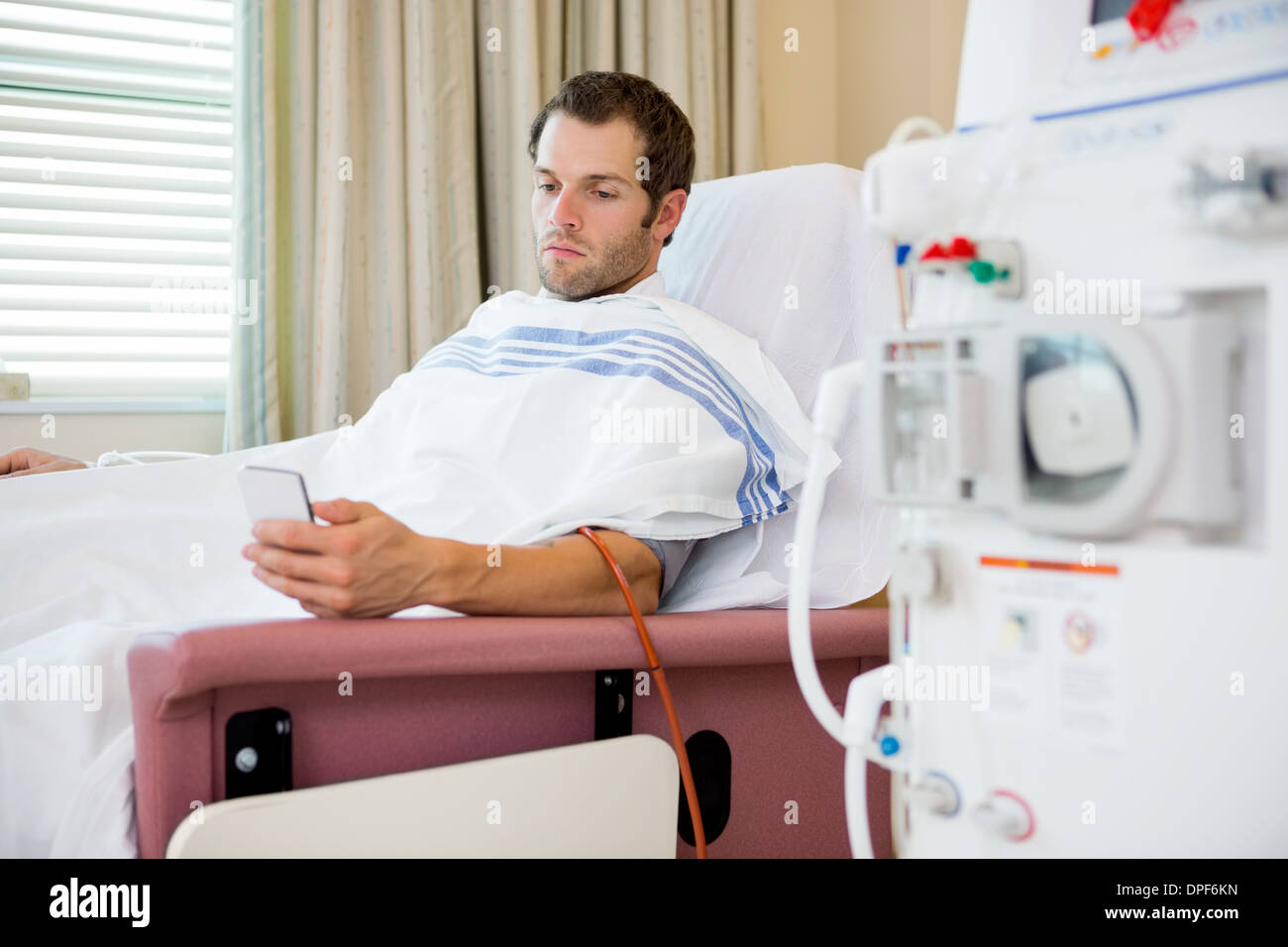 Patient Using Mobilephone at Dialysis Center Stock Photo - Alamy