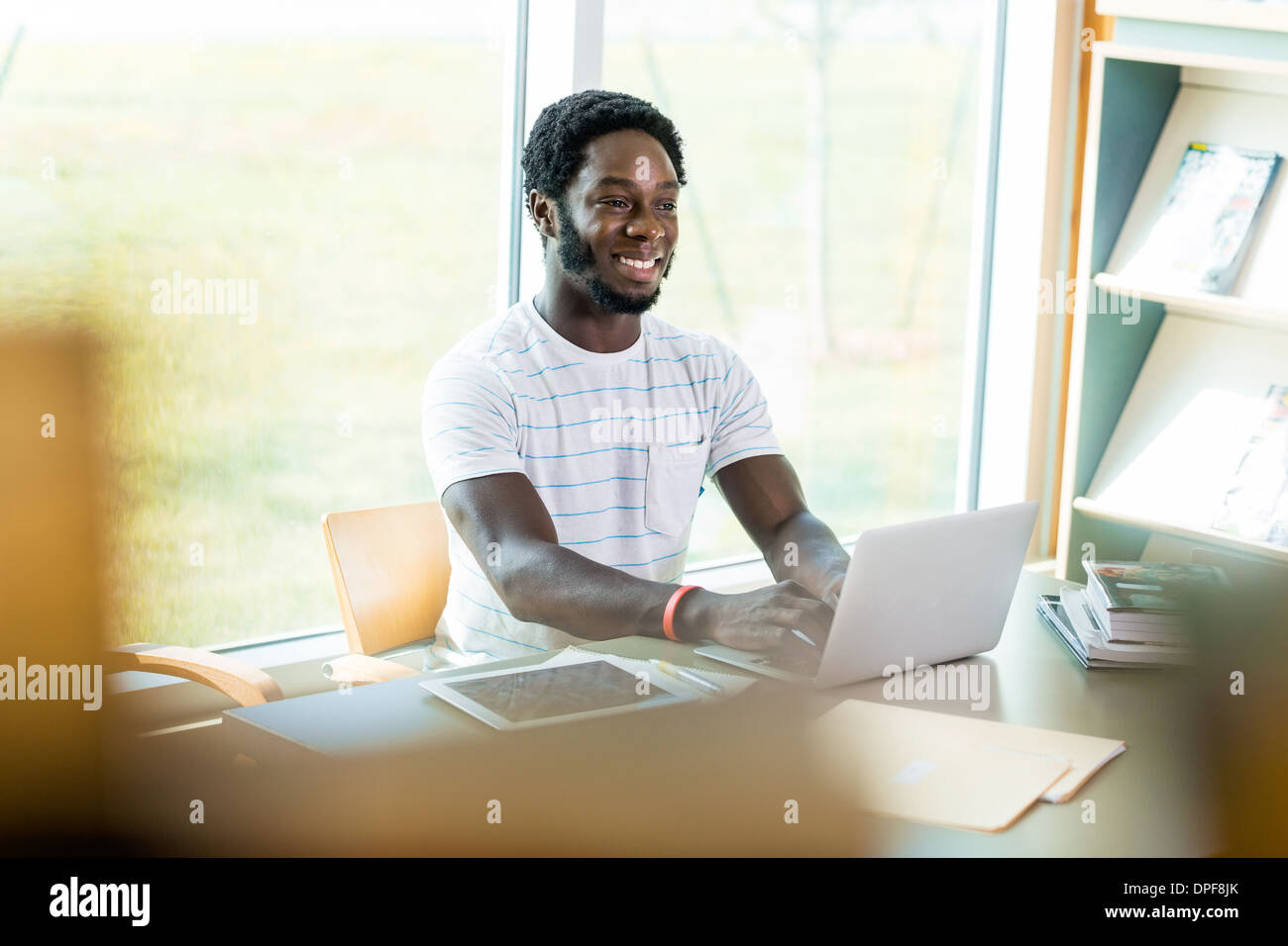 Student Using Laptop While Studying In Library Stock Photo - Alamy