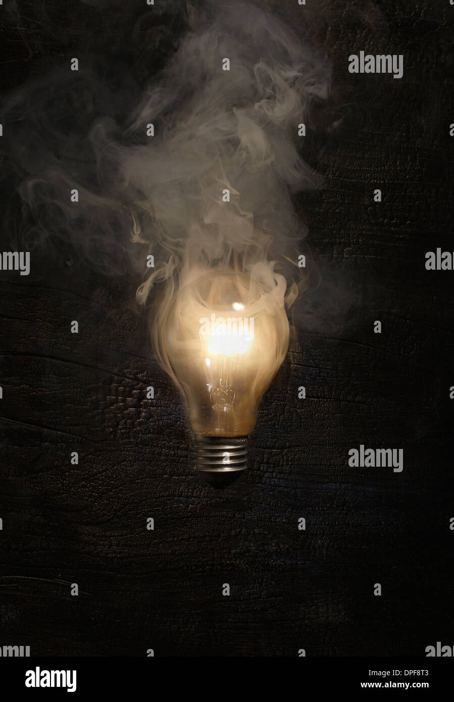 Still life of smoking illuminated lightbulb Stock Photo - Alamy