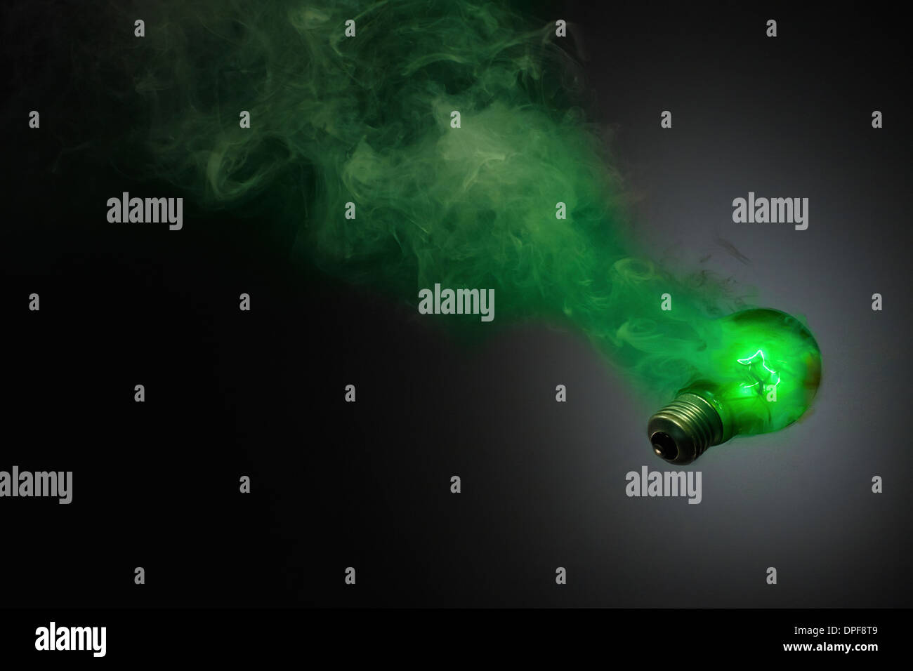 Still life of green smoking illuminated lightbulb Stock Photo - Alamy