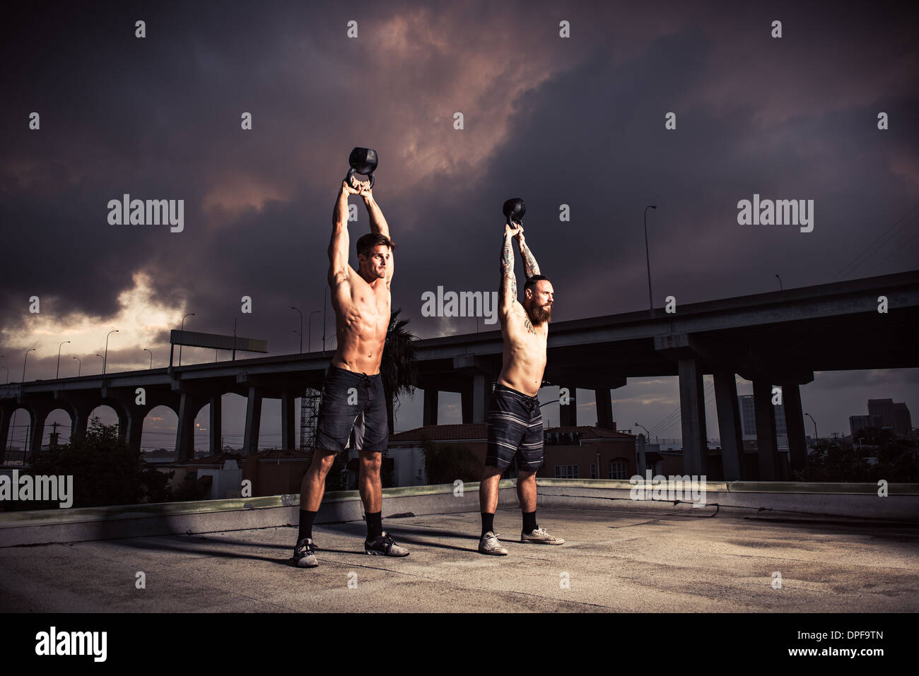 Two men training with kettlebells on gymnasium rooftop Stock Photo - Alamy