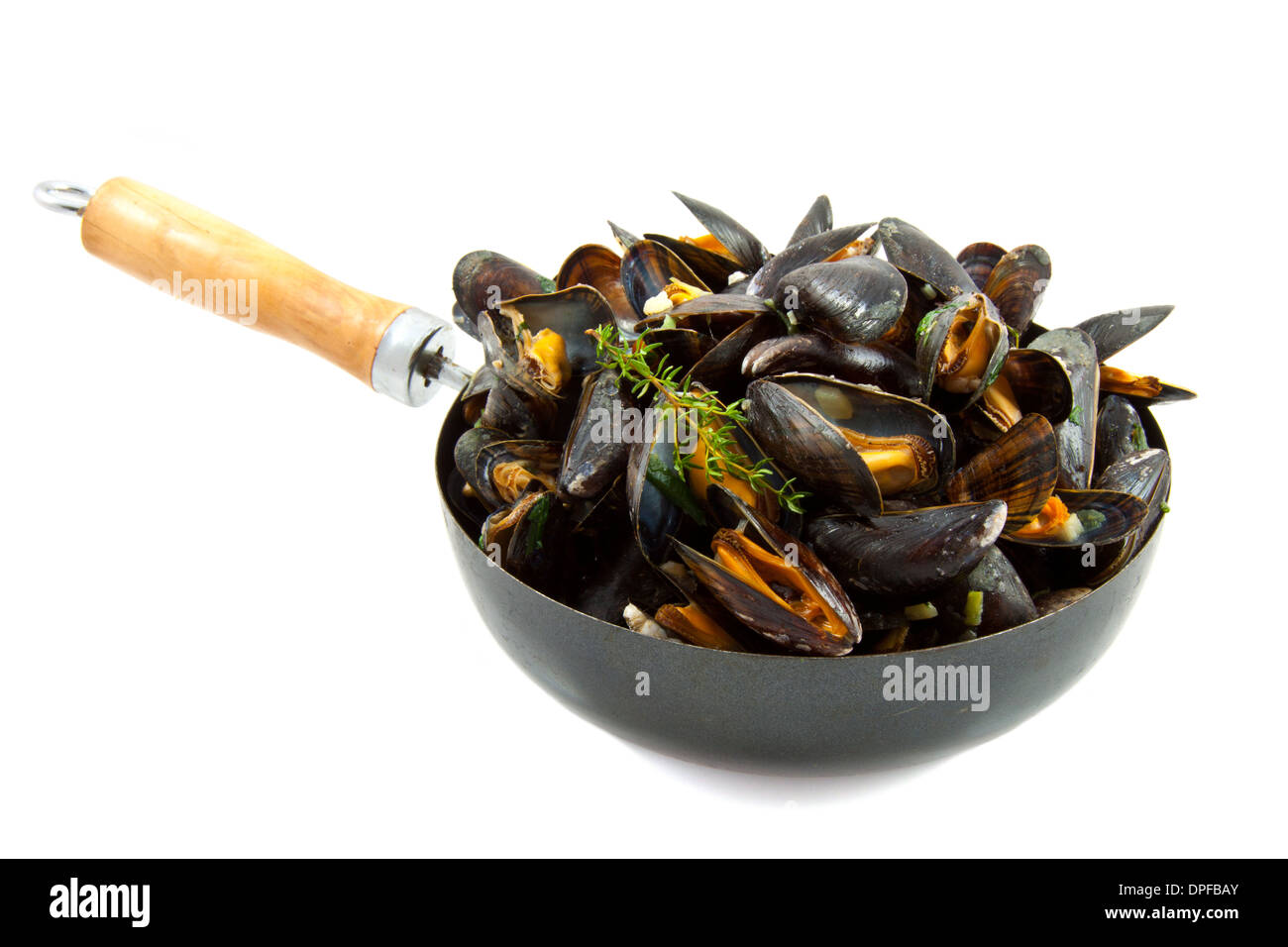 Mussels in a pan with herbs isolated over white Stock Photo - Alamy