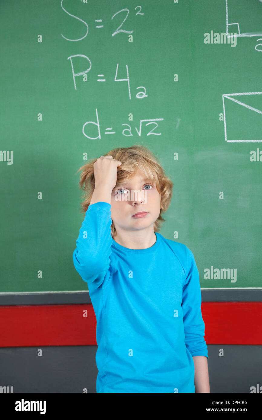 Sad Schoolboy Standing Against Board In Classroom Stock Photo - Alamy Sad Schoolboy Standing Against Board In Classroom Stock Photo - Alamy