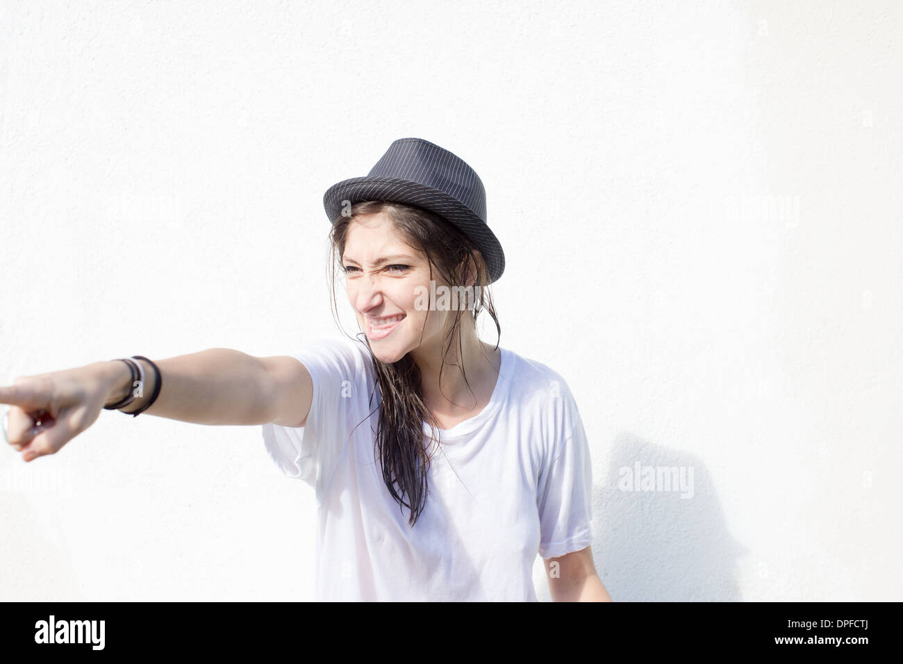 Young woman with attitude pointing finger Stock Photo - Alamy