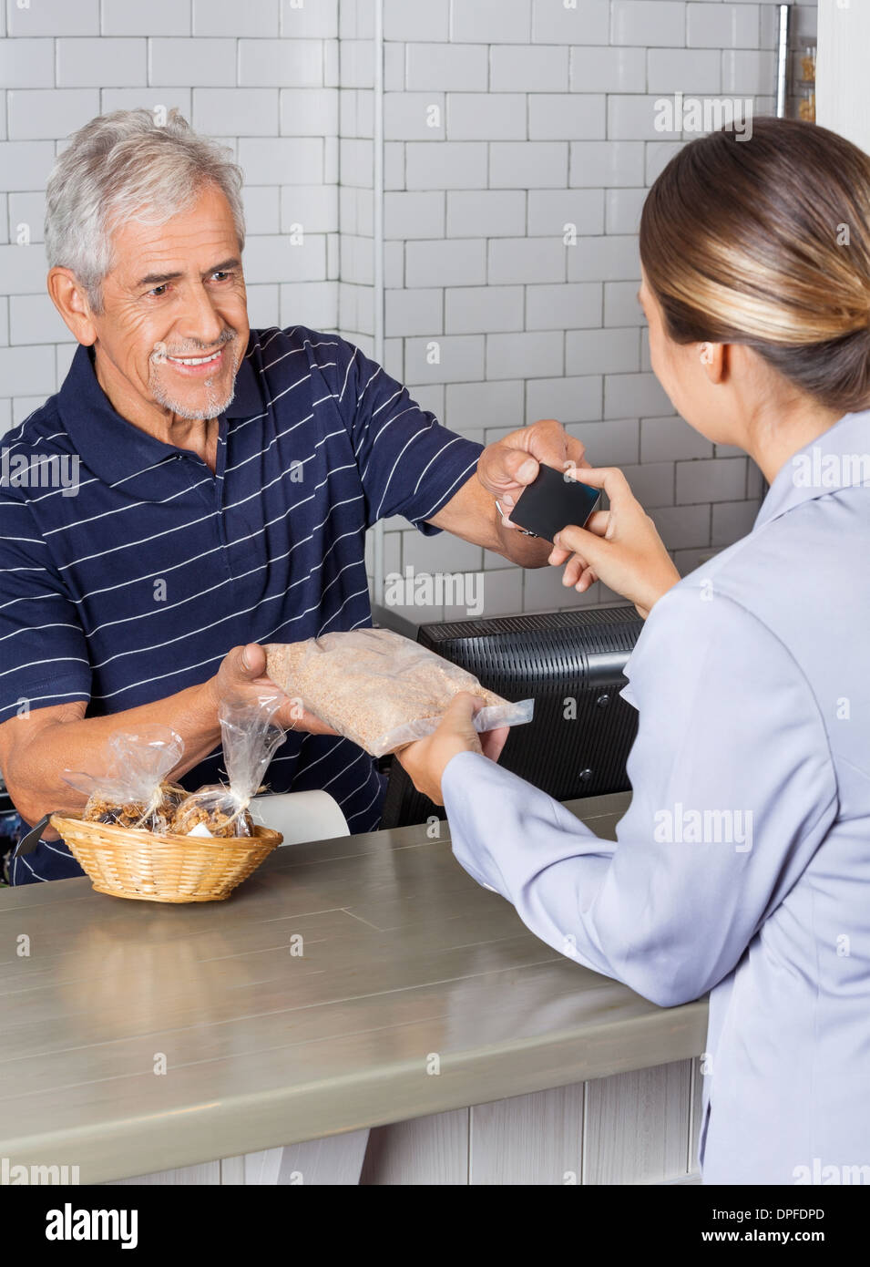 Female Customer Making Credit Card Payment At Counter Stock Photo - Alamy