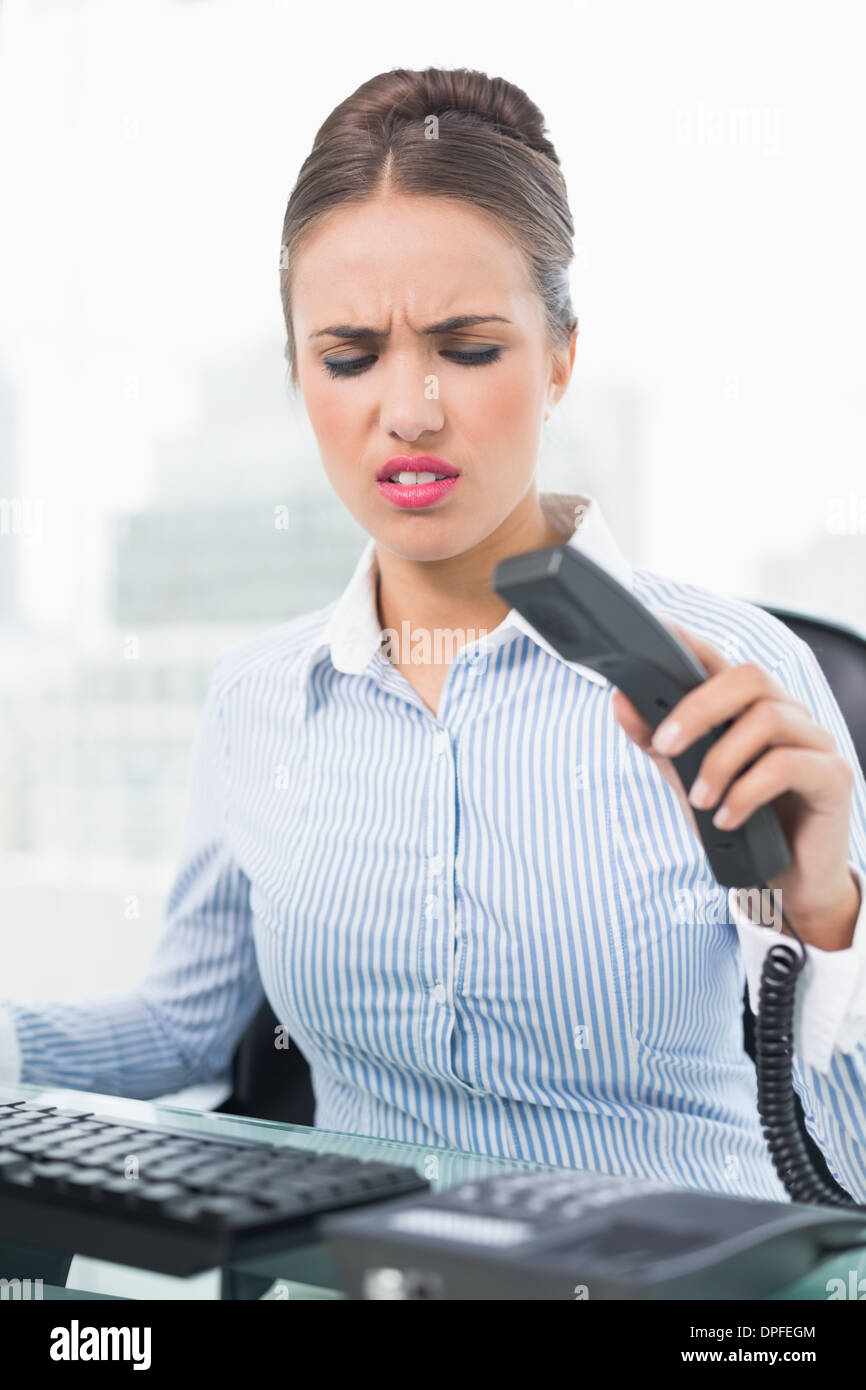 Angry brunette businesswoman hanging up the phone Stock Photo - Alamy