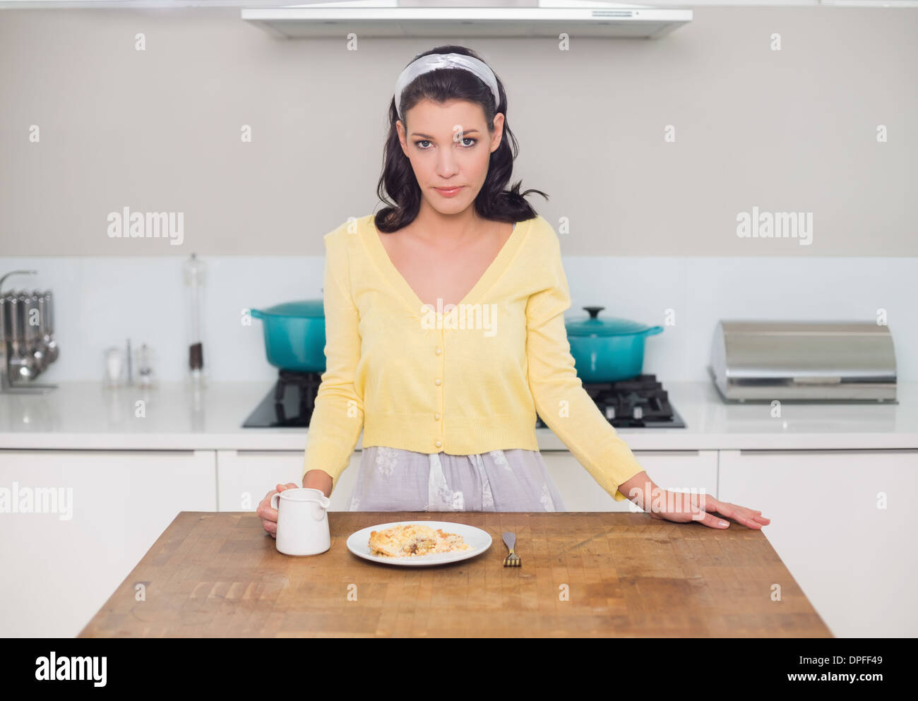Serious gorgeous model having dessert posing Stock Photo - Alamy